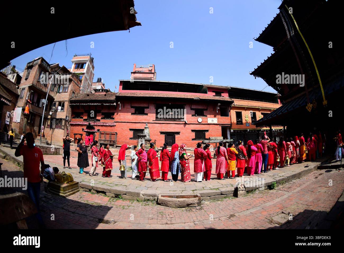 Nepalese devotees line up to offer ritual prayers in the premises of ...