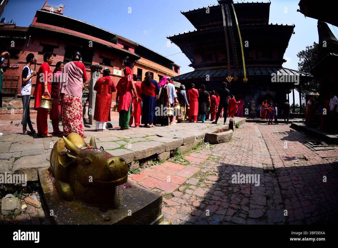 Nepalese devotees line up to offer ritual prayers in the premises of ...