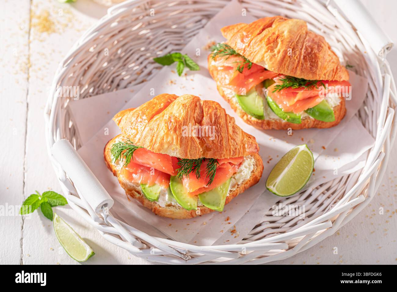 Hot and golden french croissant with fish and avocado. Croissants as ...