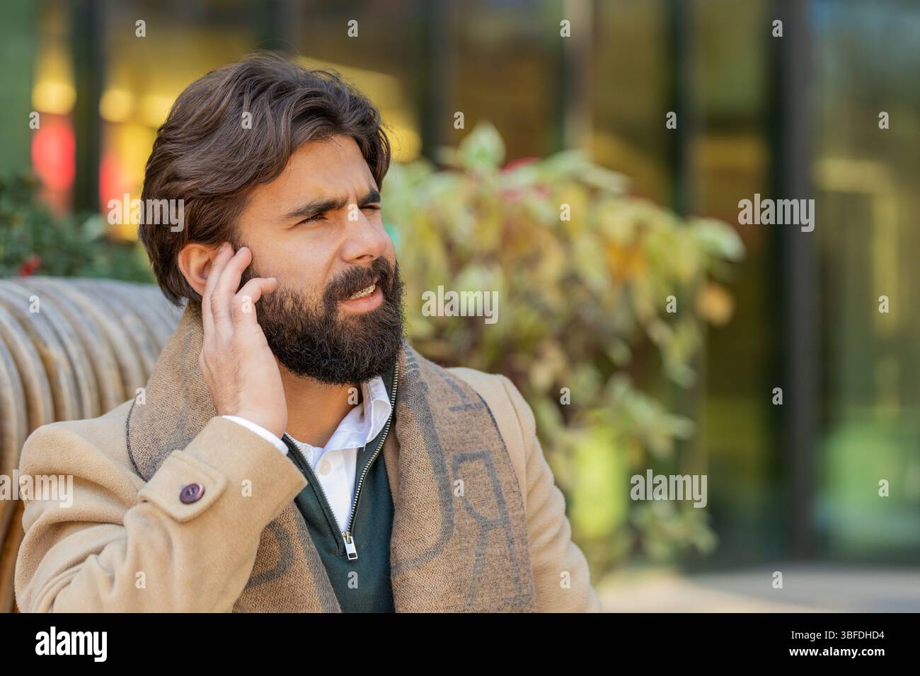 Ear pain. Indian young businessman tourist suffers from earache ...