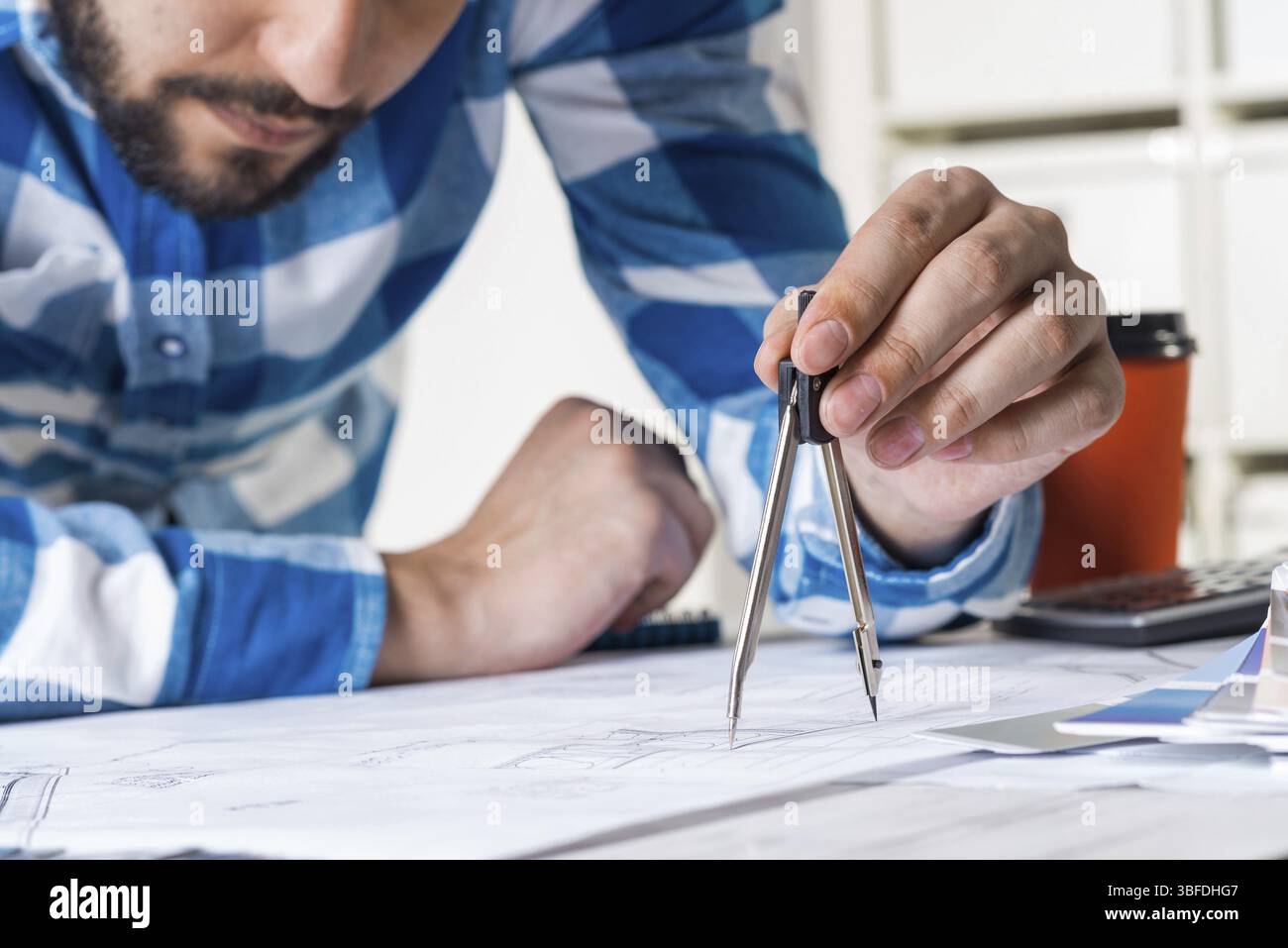 Man measuring with compass divider on construction blueprint. Architect ...