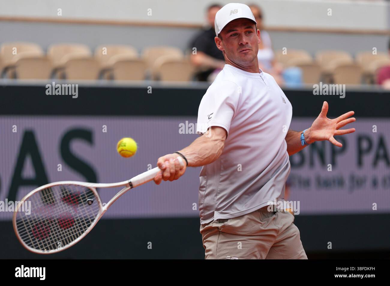 Tommy Paul of the U.S. returns the ball to Australia's Alexei Popyrin ...