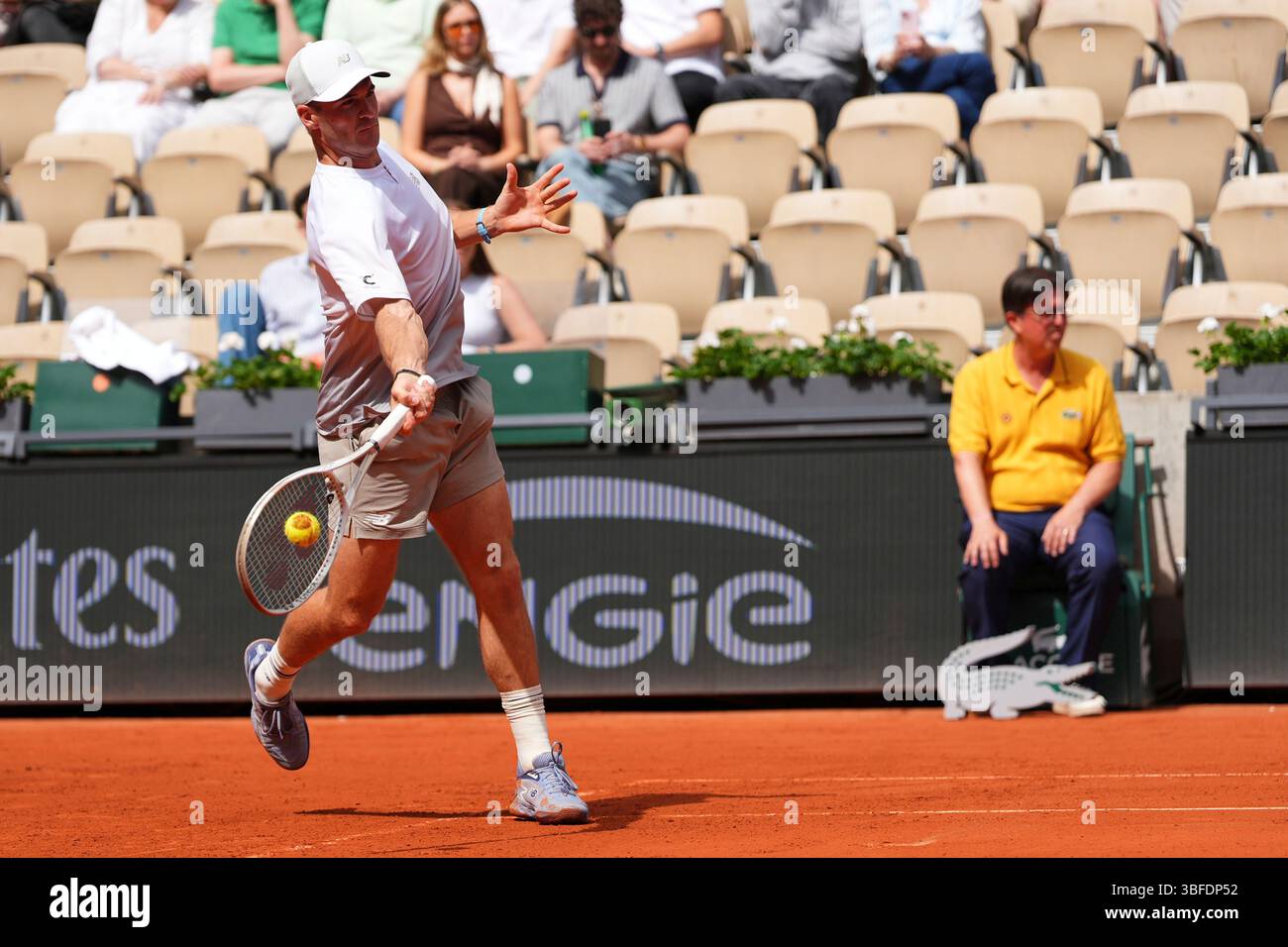 Tommy Paul of the U.S. returns the ball to Australia's Alexei Popyrin ...