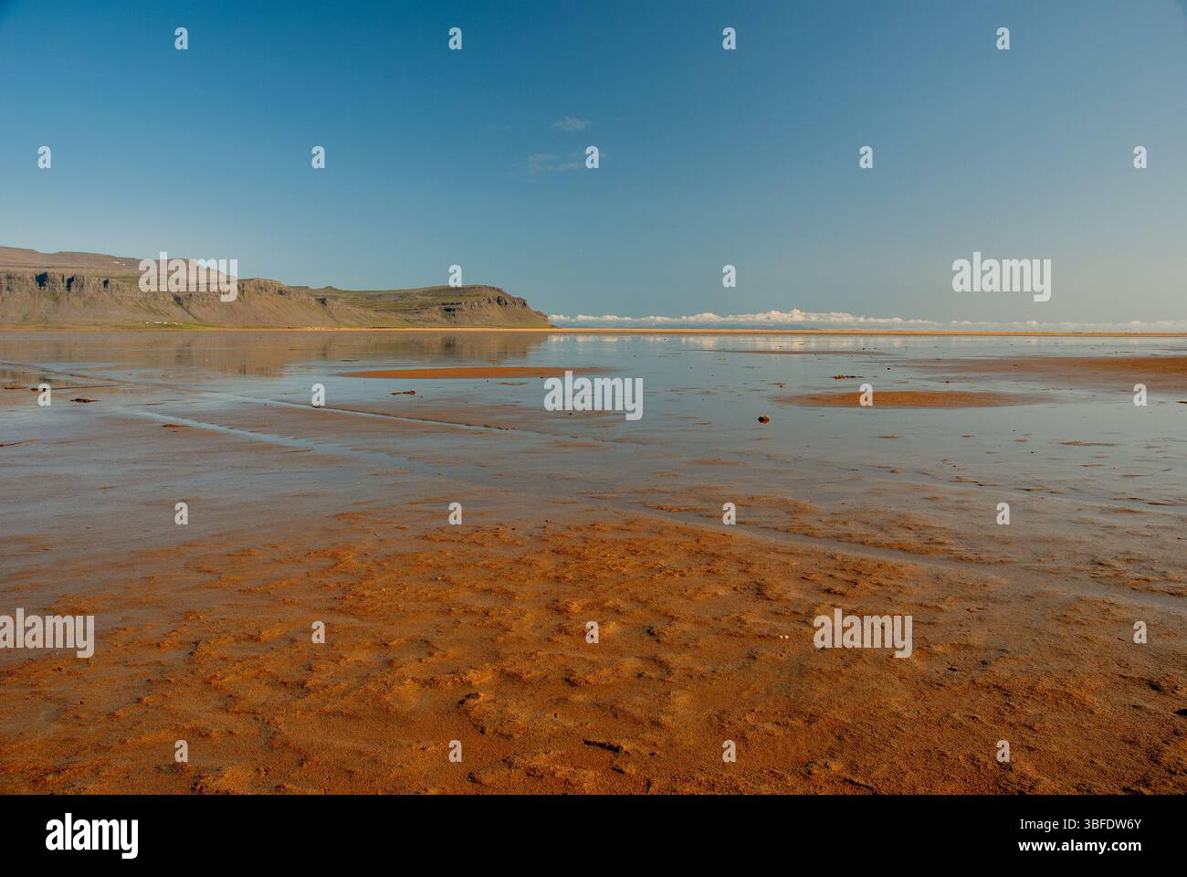 Raudisandur Beach, with its striking red sands and clear blue sky ...