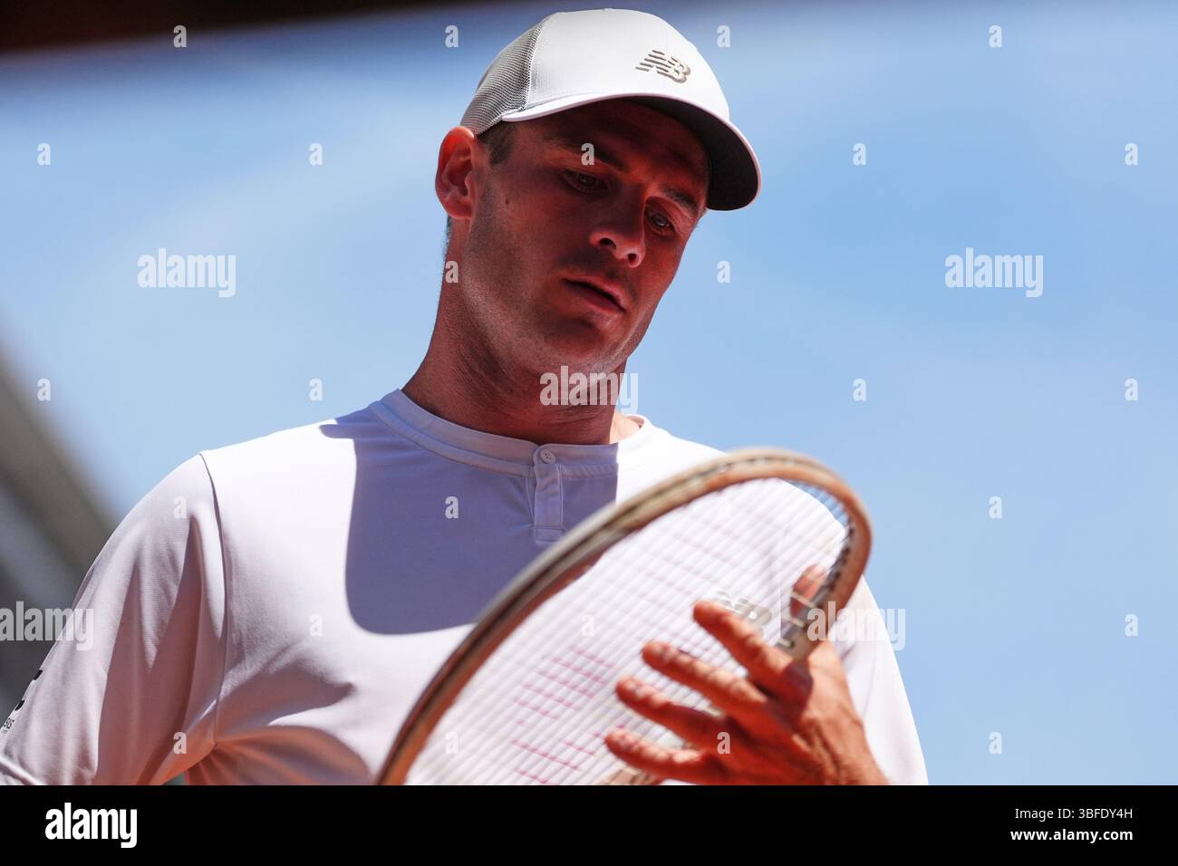Tommy Paul of the U.S. checks his racket as he plays Australia's Alexei ...