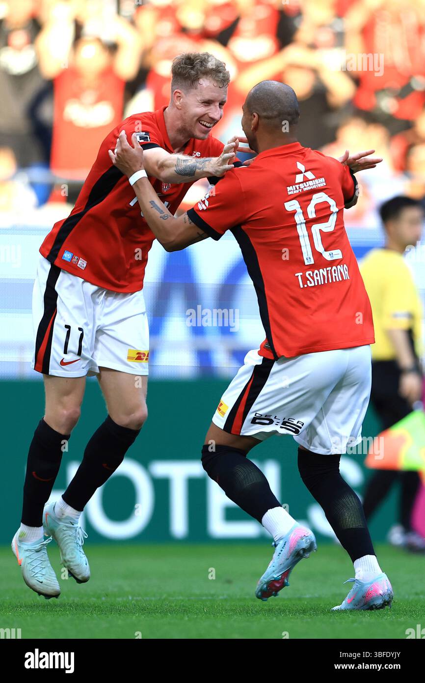 Samuel Gustafson of Urawa Red Diamonds (L) reacts after scoring in the ...