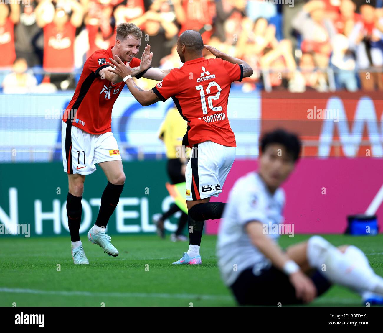 Samuel Gustafson of Urawa Red Diamonds (L) reacts after scoring in the ...