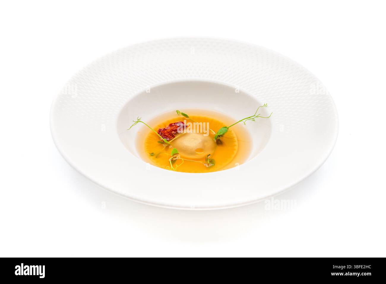 Ravioli consomme on a white porcelain plate. Healthy eating concept ...