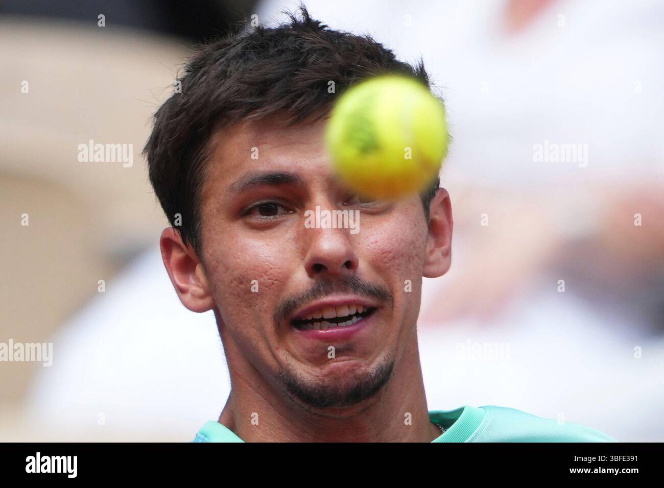 Australia's Alexei Popyrin eyes the ball as he plays Tommy Paul of the ...