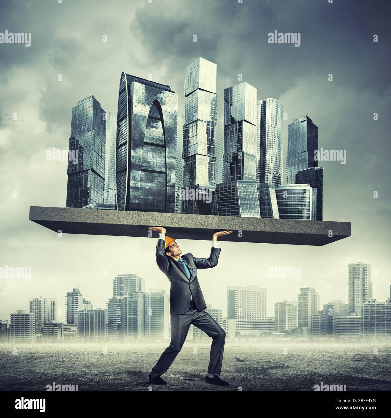 Engineer man in suit and helmet lifting wall with city model above head ...