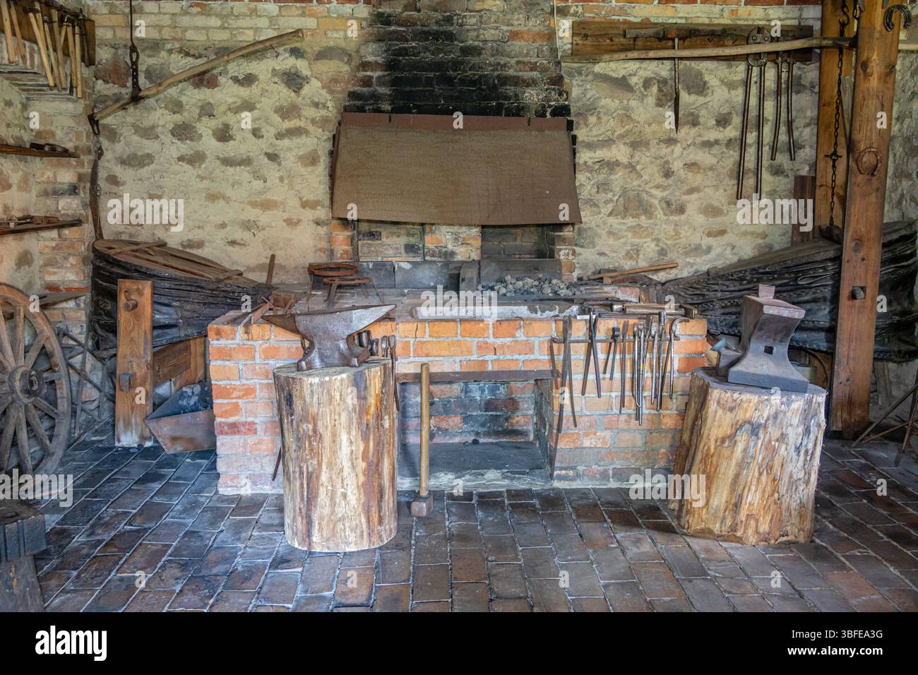 Equipment of a historic forge with a fireplace and bellows Stock Photo ...