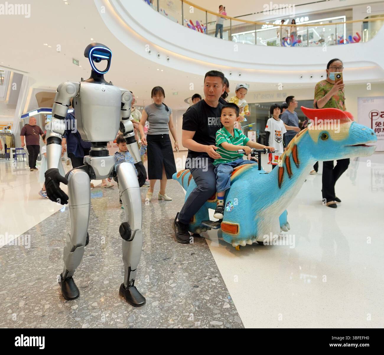 YANTAI, CHINA - JUNE 1, 2025 - People are watching a UNITREE G1 ...