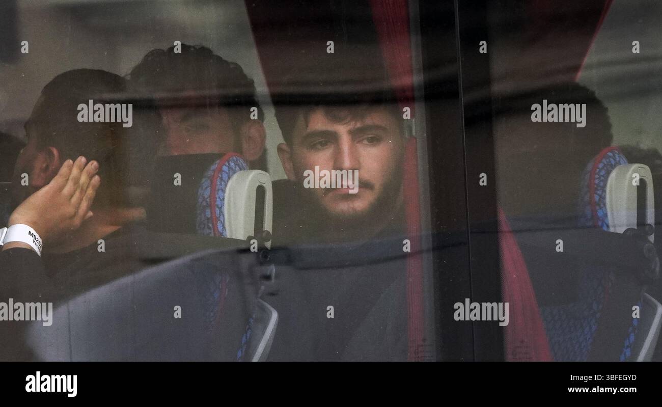 A group of people believed to be migrants are driven away from the ...