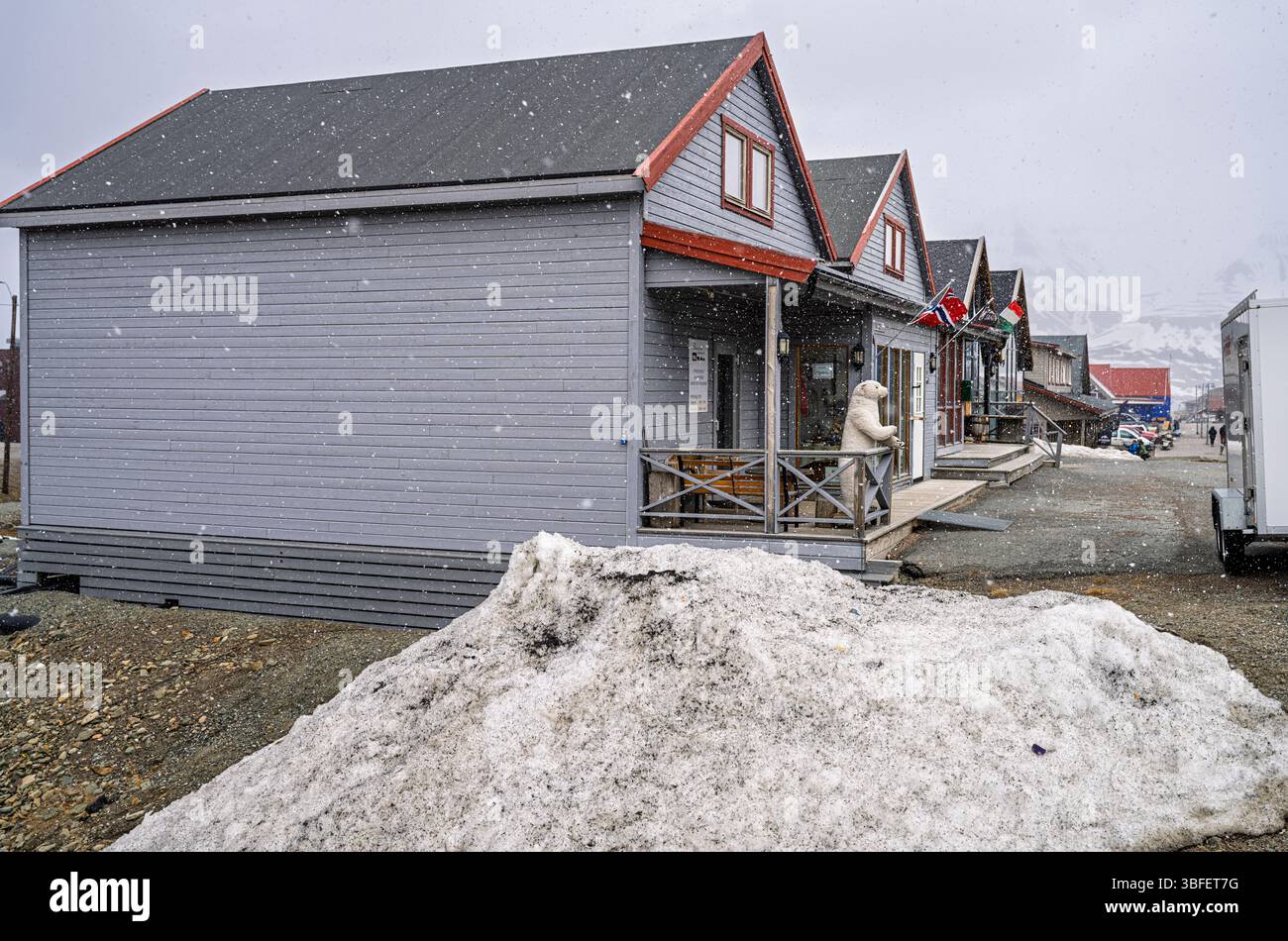 Shops along the main shopping street on a cold, bleak, snowy day in the ...