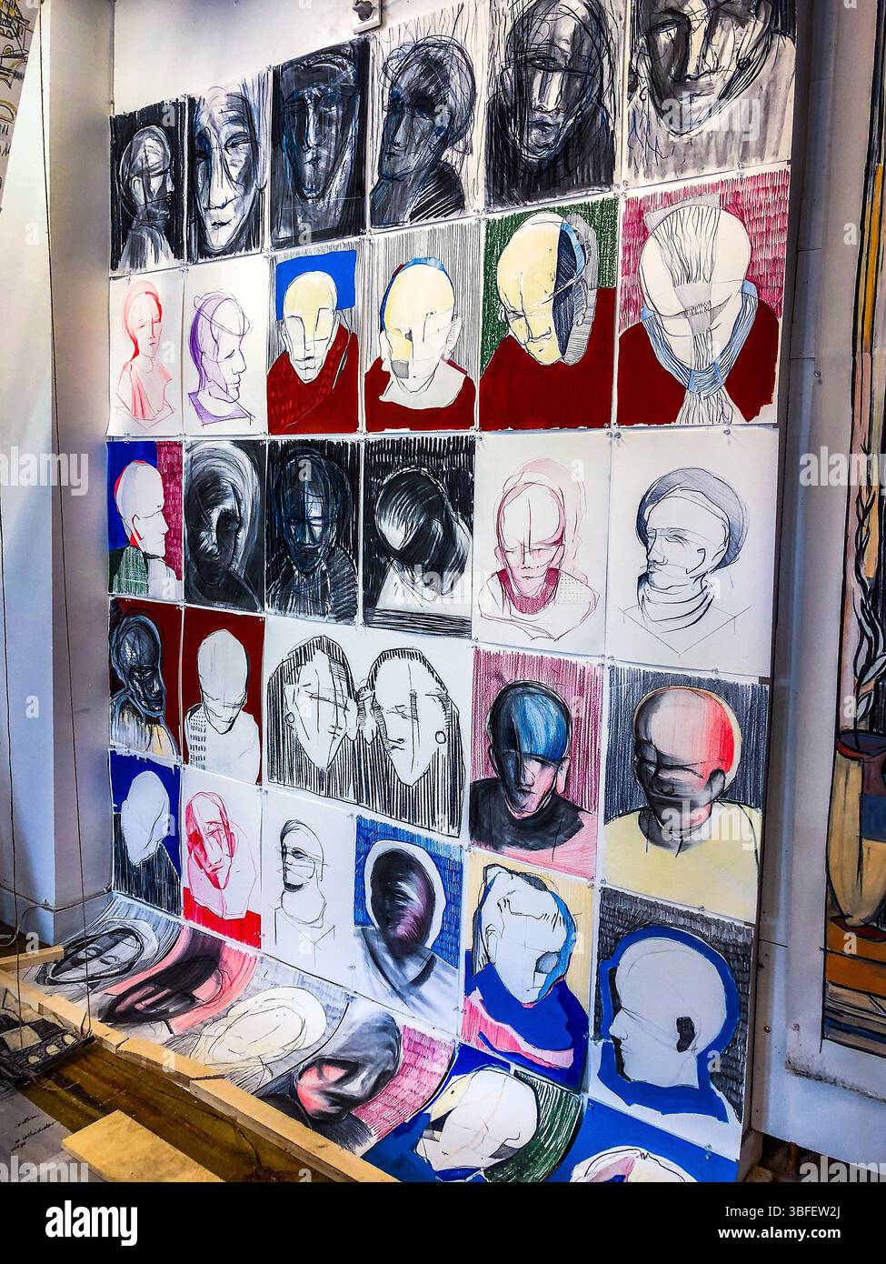 Wall covered in painted and drawn faces and heads art in the 59 Rivoli ...