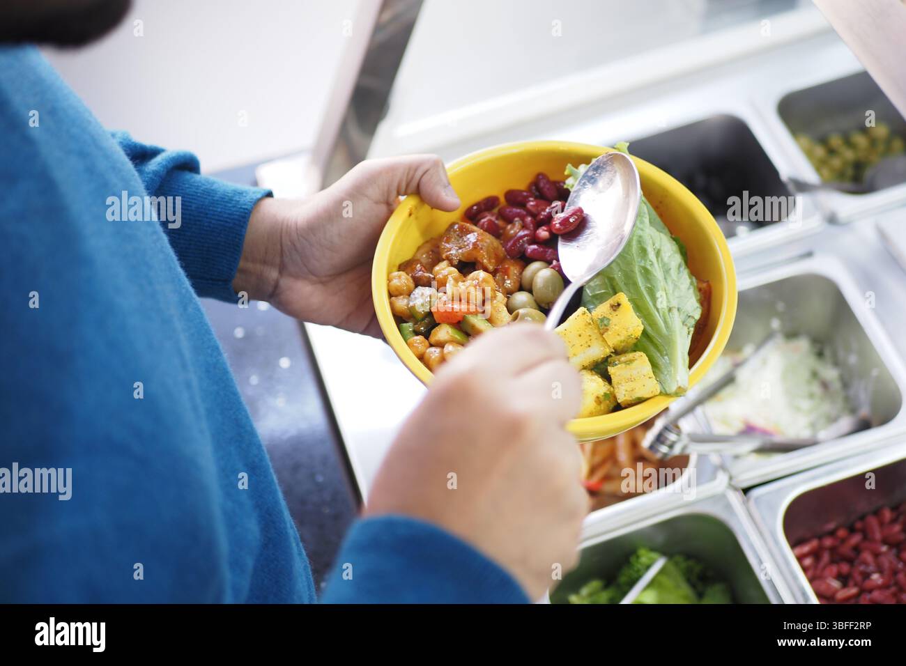 Healthy meal preparation at a cafeteria buffet line Stock Photo - Alamy
