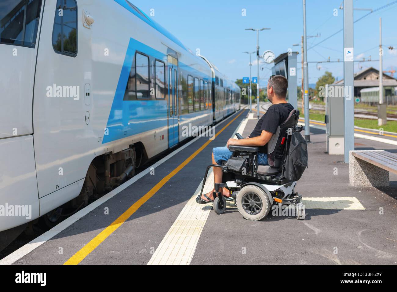 Wheelchair user using accessible train travel is waiting at a train ...