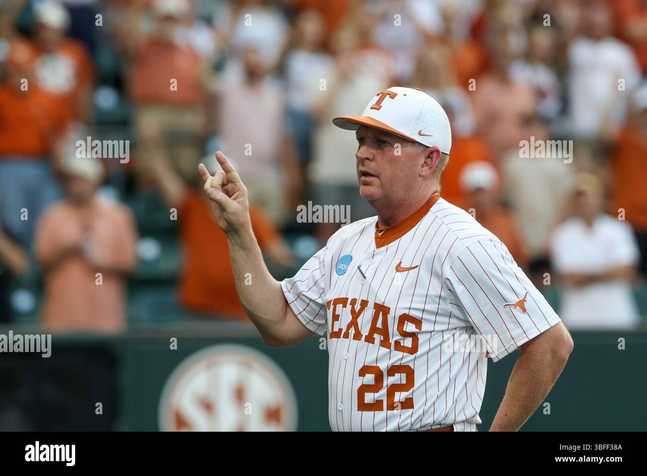 AUSTIN, TX - MAY 31: Texas head coach Jim Schlossnagle holds the Horns ...