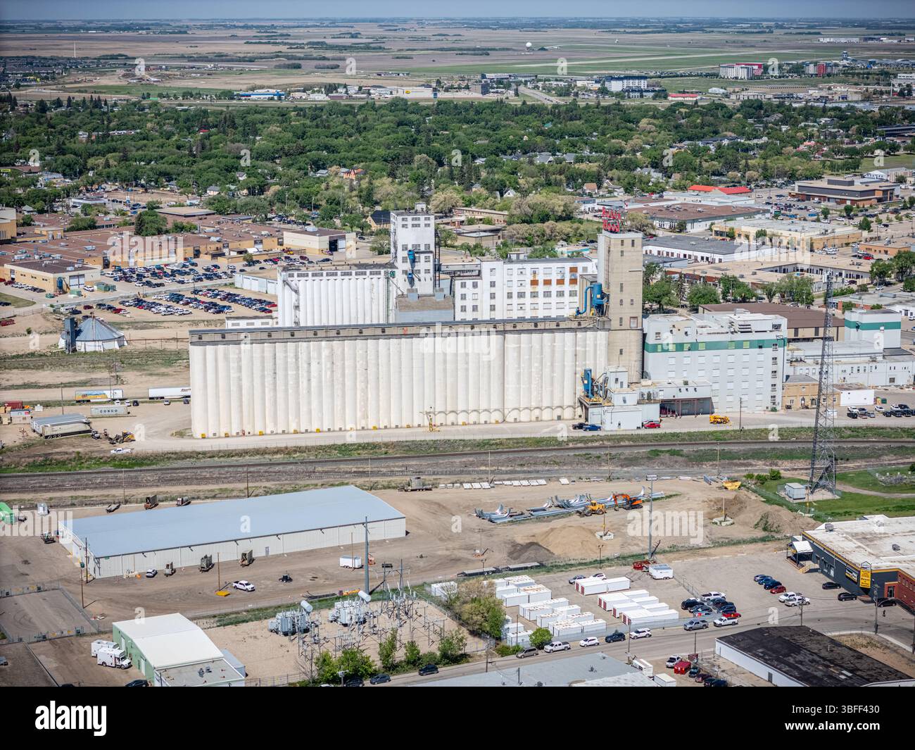 Grain silo is seen from above in a city. The silo is surrounded by a ...
