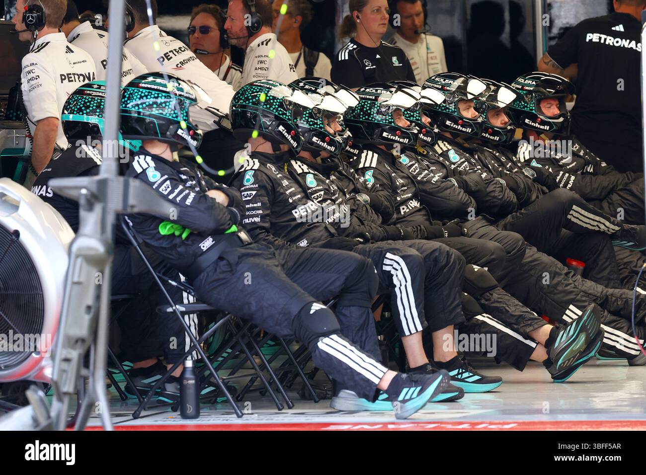 Mercedes mechanics sit in the garage during the Spanish Grand Prix ...