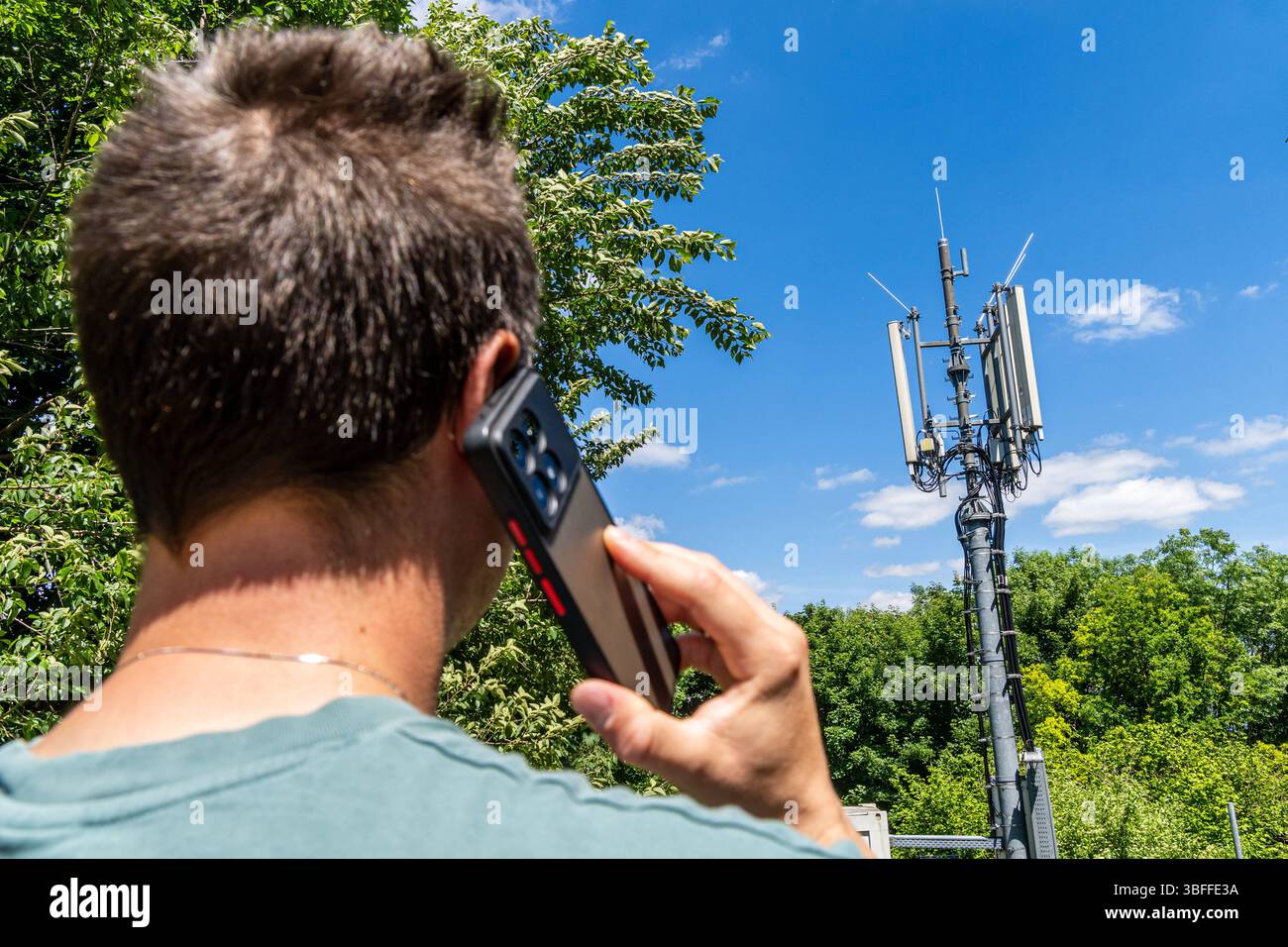 Munich, Bavaria, Germany - May 30, 2025: A man makes a phone call with ...