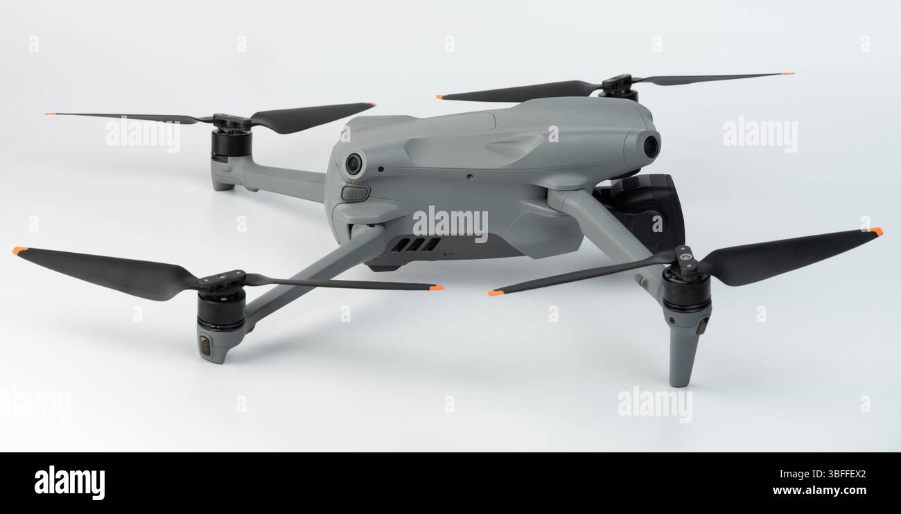 Quadcopter with open wings side view isolated on studio background ...