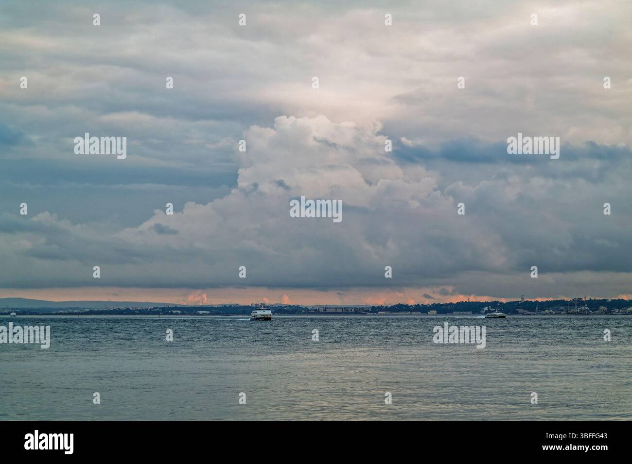 A wide, calm body of water stretches into the distance, featuring ...