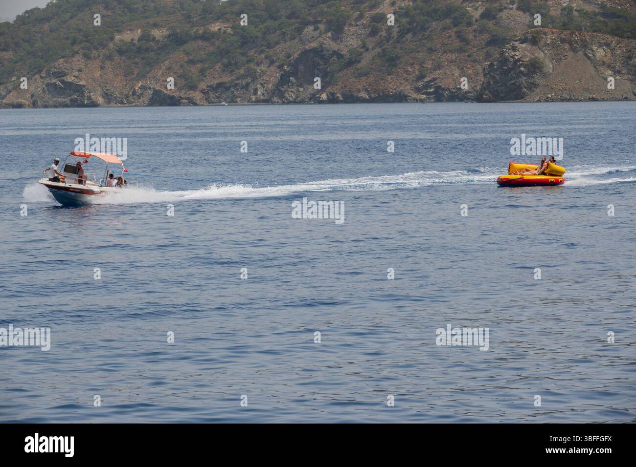 the excitement of a summer holiday, featuring a "Water Sport" boat ...