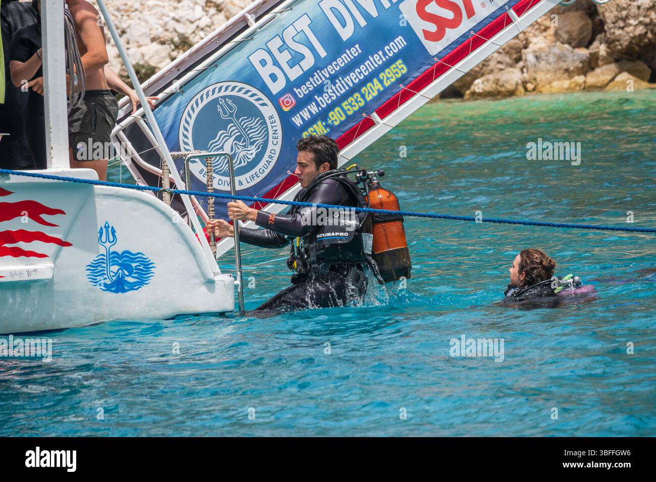 A vibrant blue dive boat, provides a platform for enthusiasts to embark ...