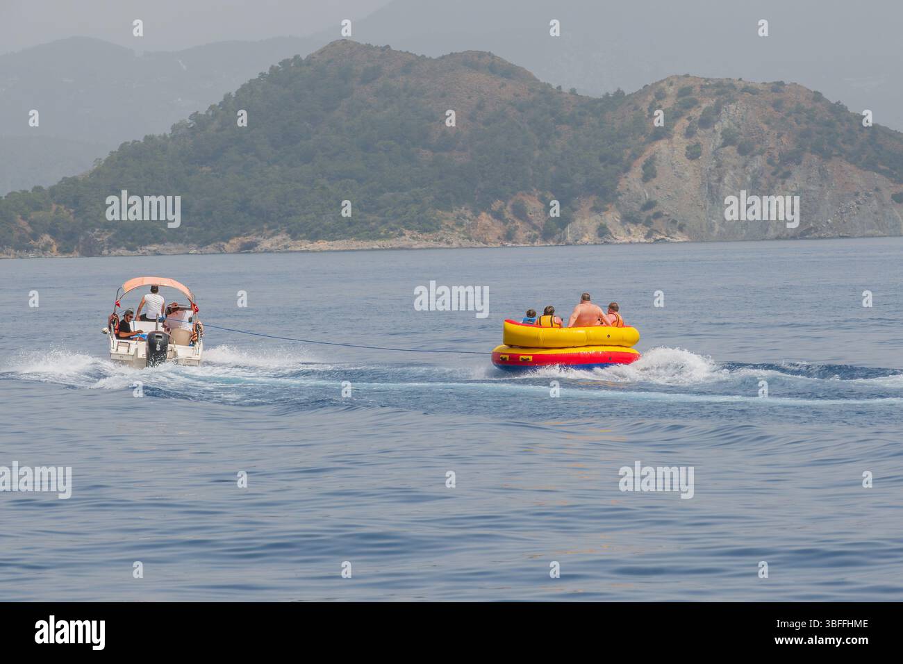 fethiye turkey 26 may 2025: Two people on a vibrant yellow and red ...