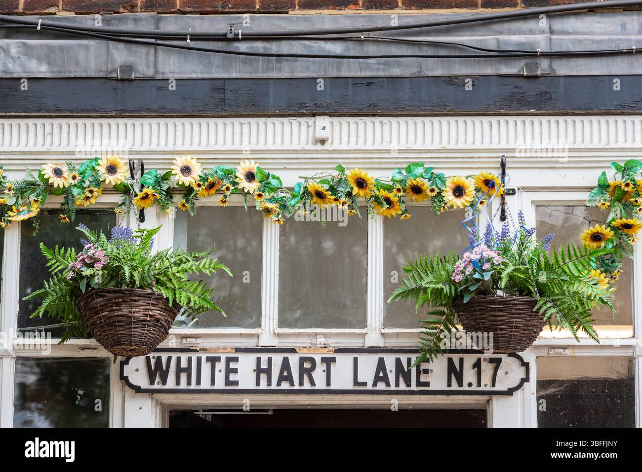 Vintage White Hart Lane N17 road sign attached to the outside of a pub ...
