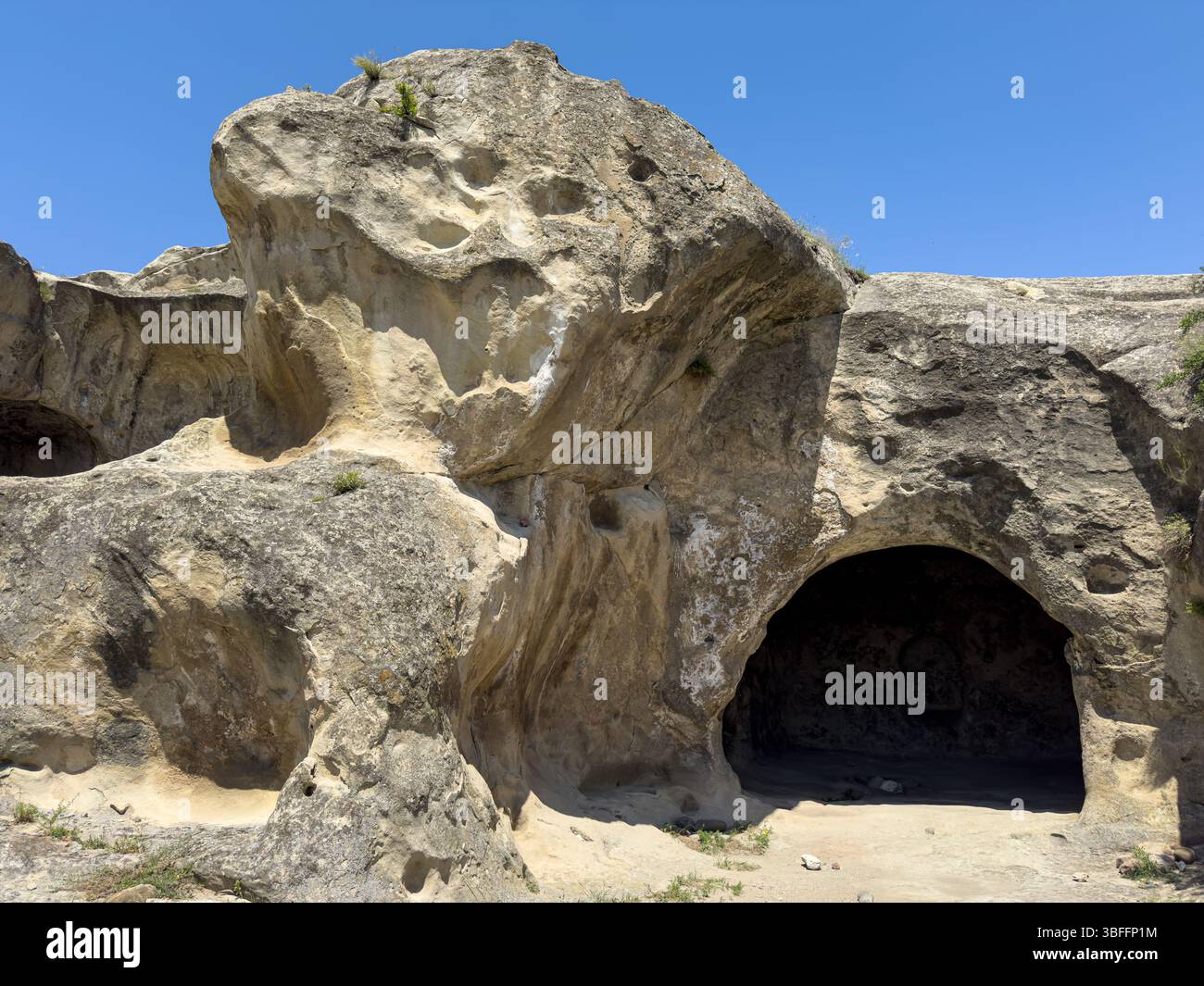 Rock cave entrance in the ancient cave city Uplistsikhe, Georgia ...