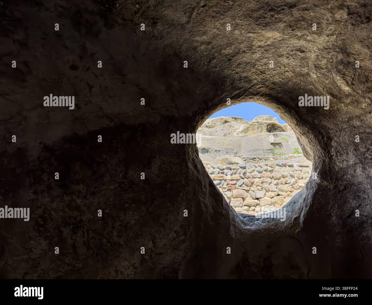 View from inside the cave through a round opening in Uplistsikhe ...