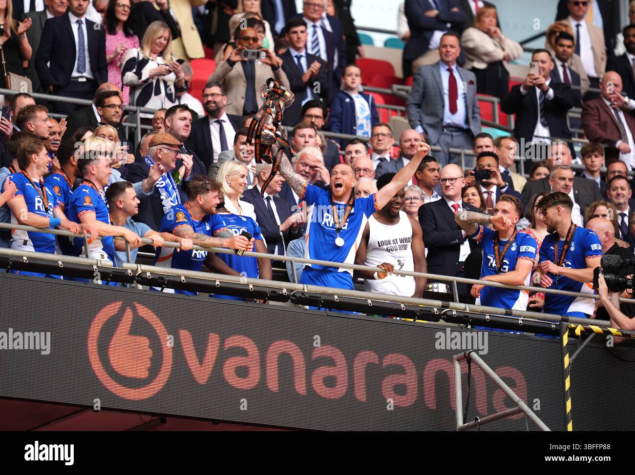 Oldham Athletic's Joe Garner lifts the trophy following the Vanarama ...