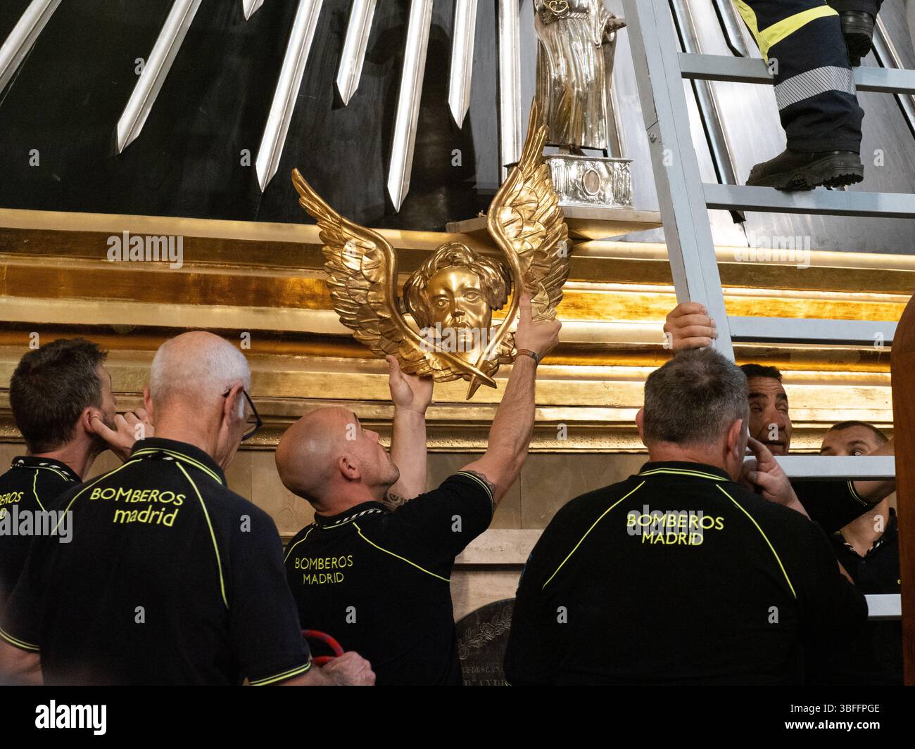 Madrid, Spain. 1st June, 2025. A firefighter holding a golden cherub ...