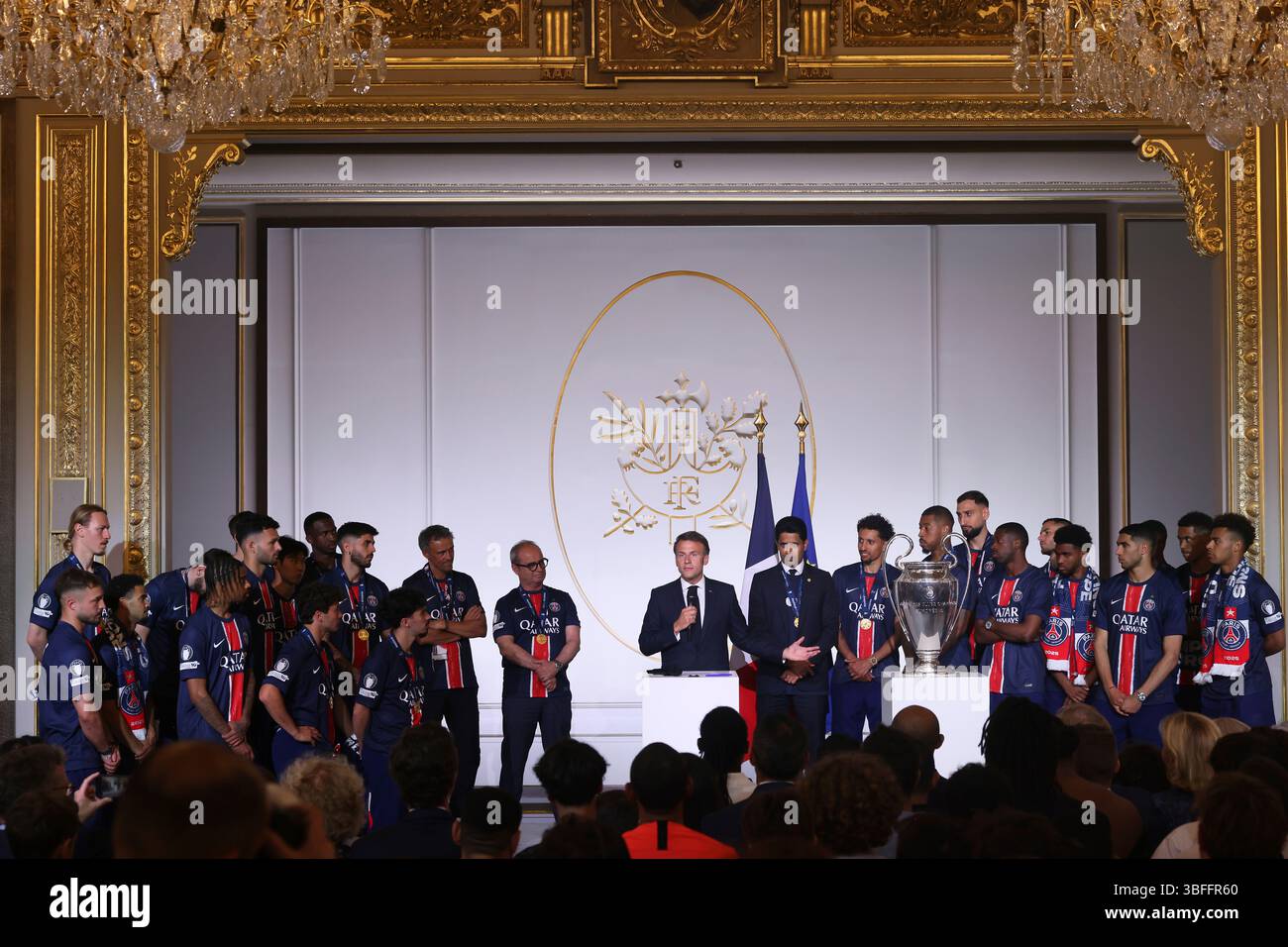 French President Emmanuel Macron, center, speaks to congratulate PSG ...