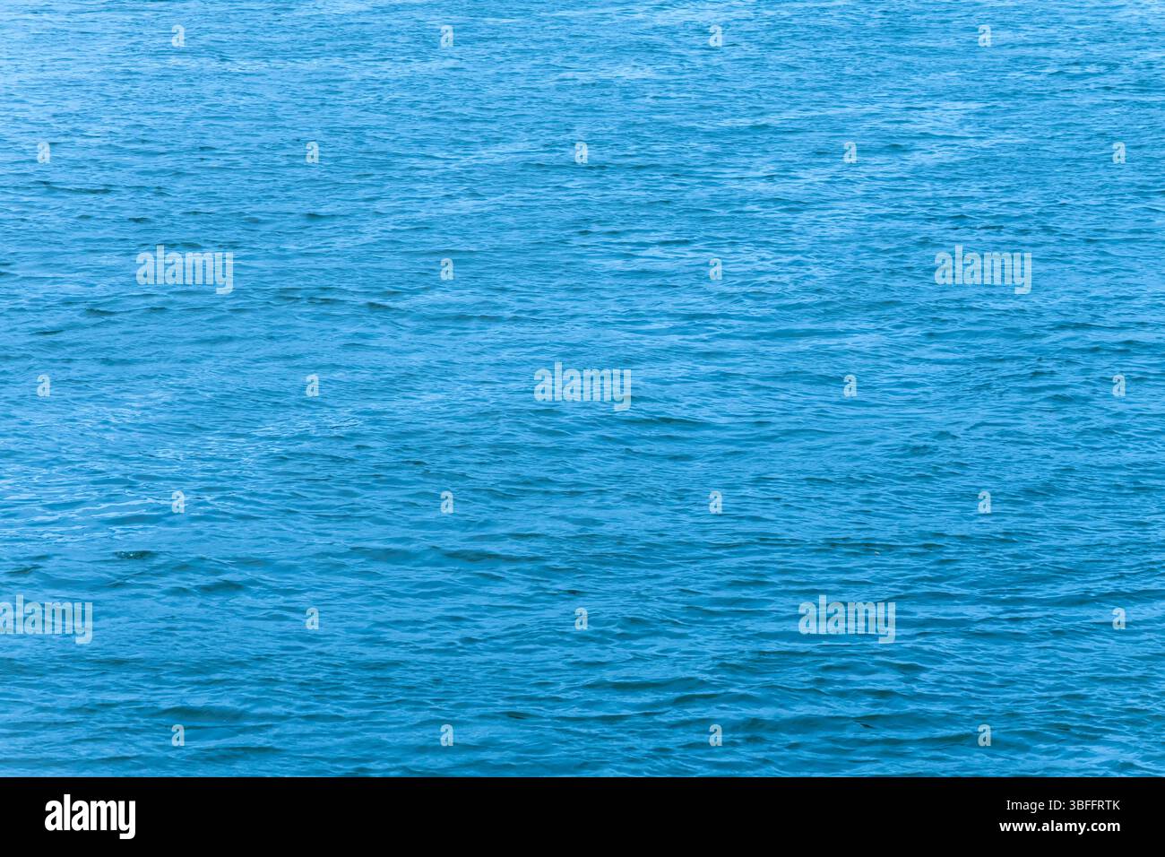 A calm sea surface with light waves against daylight is the perfect ...