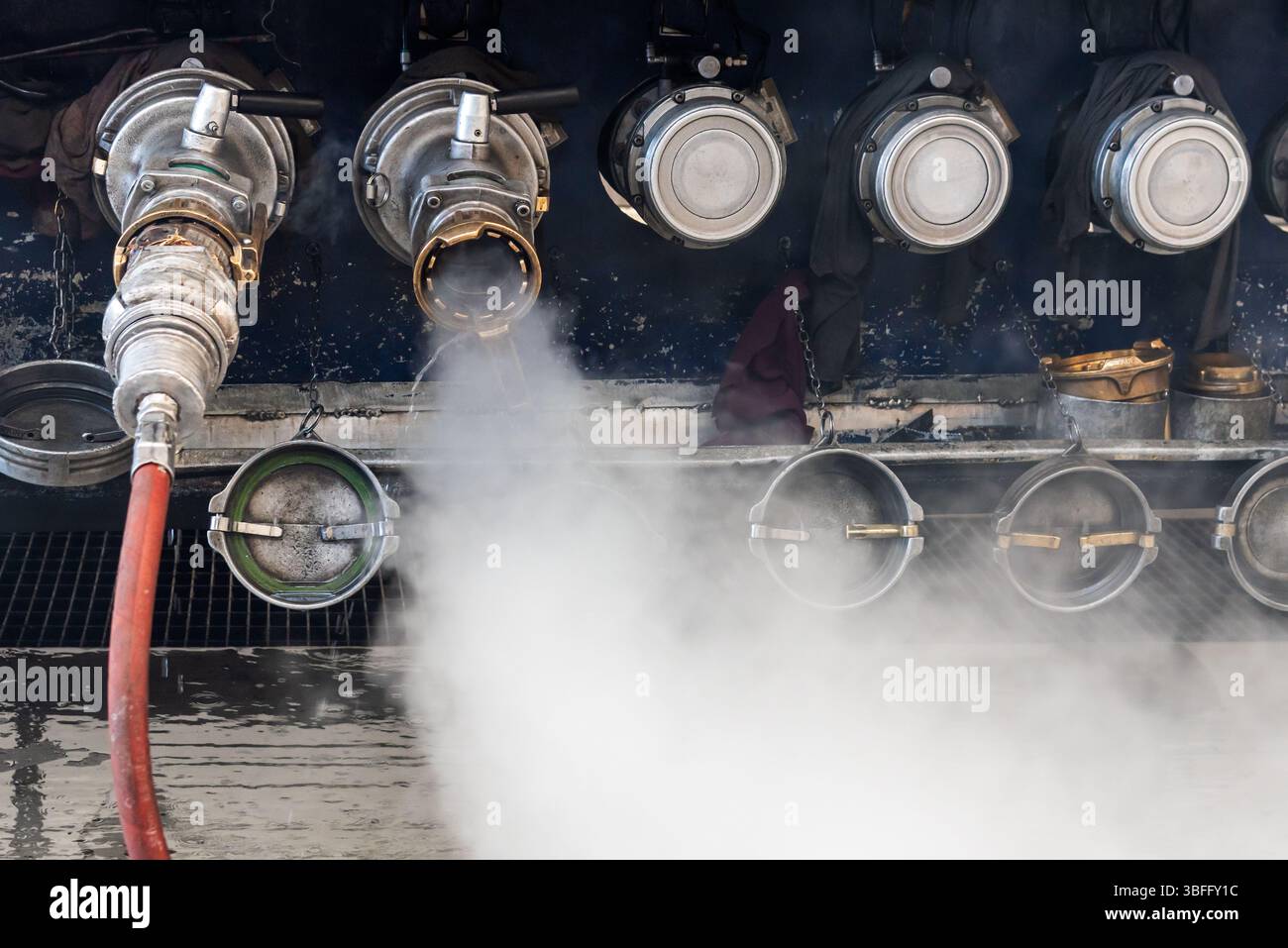 Loading or unloading outlets of a fuel tanker truck at a wash station ...