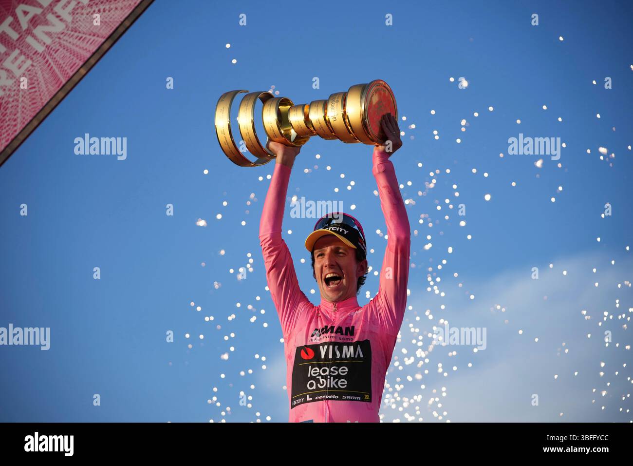 Britain's Simon Yates lifts the trophy after winning the Giro d'Italia ...