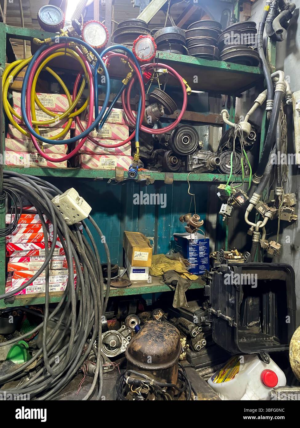 motor repair shop tools and auto parts organized on shelves in ...