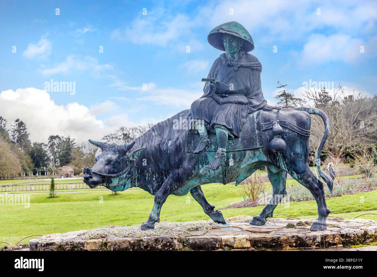 Bronze sculpture of Japanese man riding an ox while reading a book ...