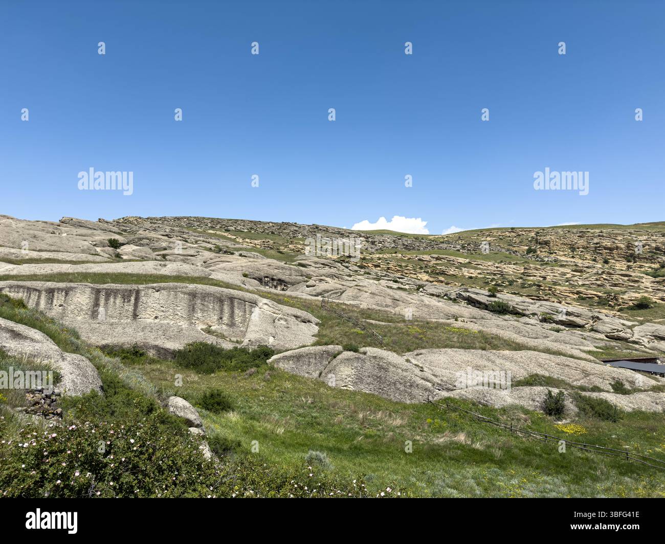 Rock formations and grasslands under clear blue sky, landscape view ...