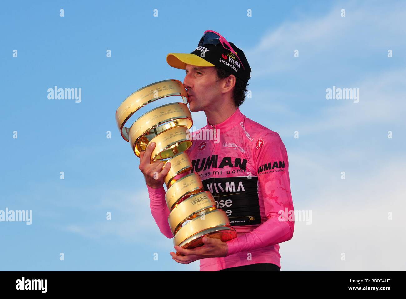 Britain's Simon Philip Yates on the podium, wearing the pink jersey of ...