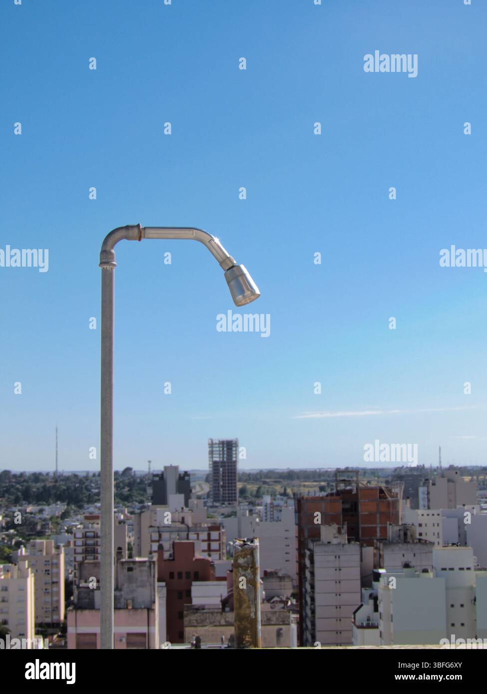 A Solitary Shower Head Stands Against a City Skyline Symbolizing the ...