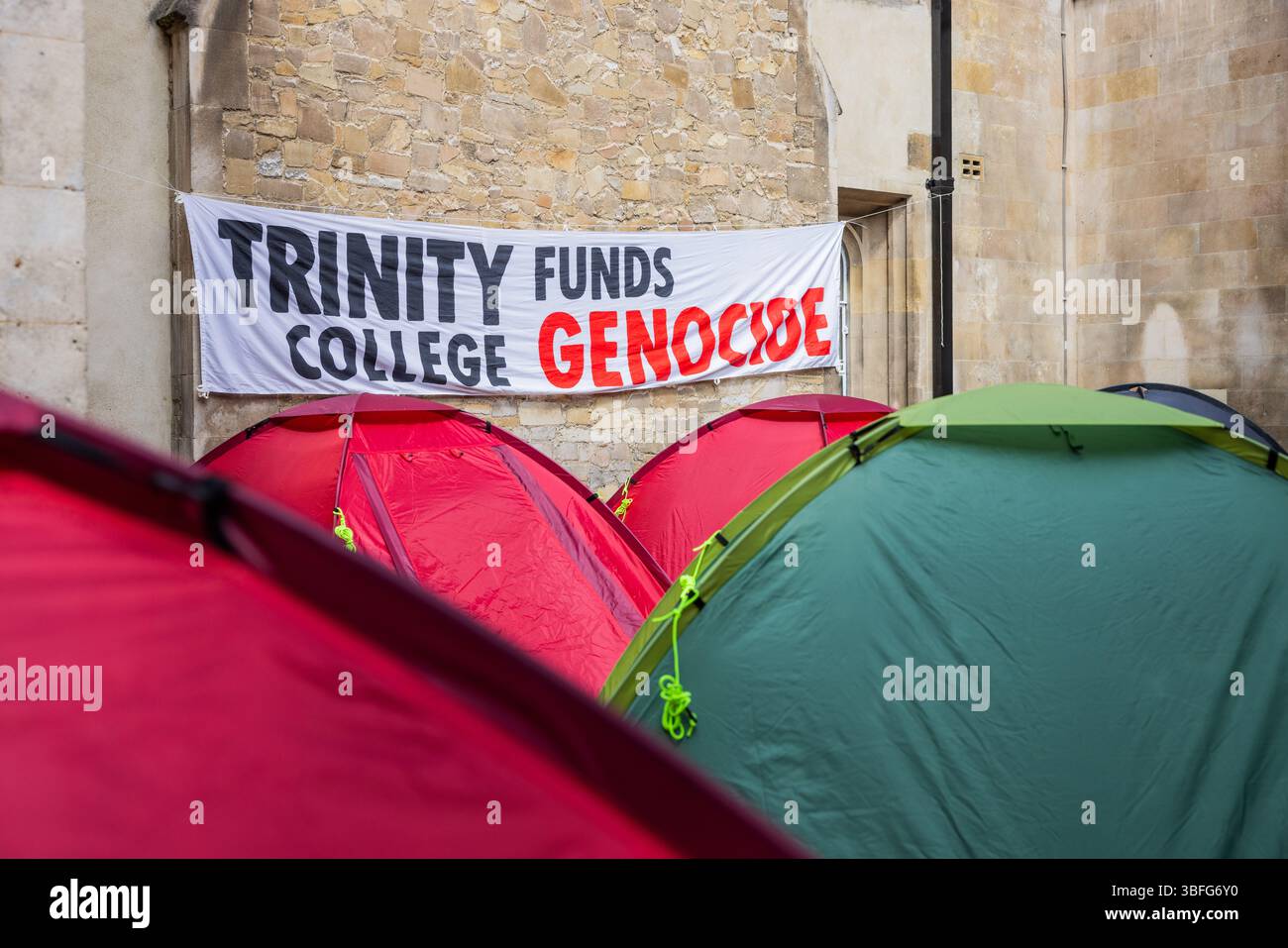 Cambridge, UK. 01 JUN, 2025. Tents and "Trinity college funds Genocide" banner on day two of a ...