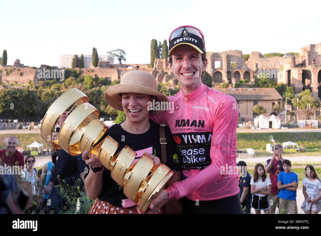 Britain's Simon Yates holds the trophy with an unidentified woman after ...