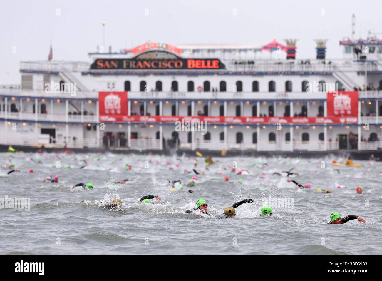 Athletes swim in the water during the "Escape From Alcatraz" triathlon ...