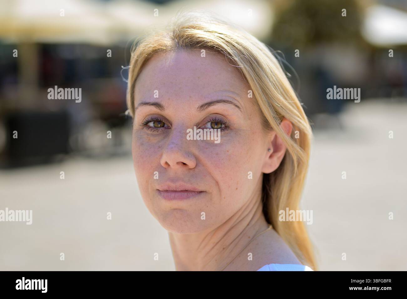 Confident close-up portrait of a woman with natural expression and ...