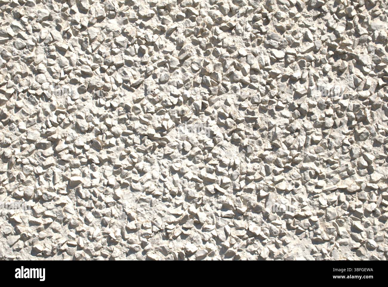 Close-up full-frame roughcast or pebble dash wall with a coarse ...