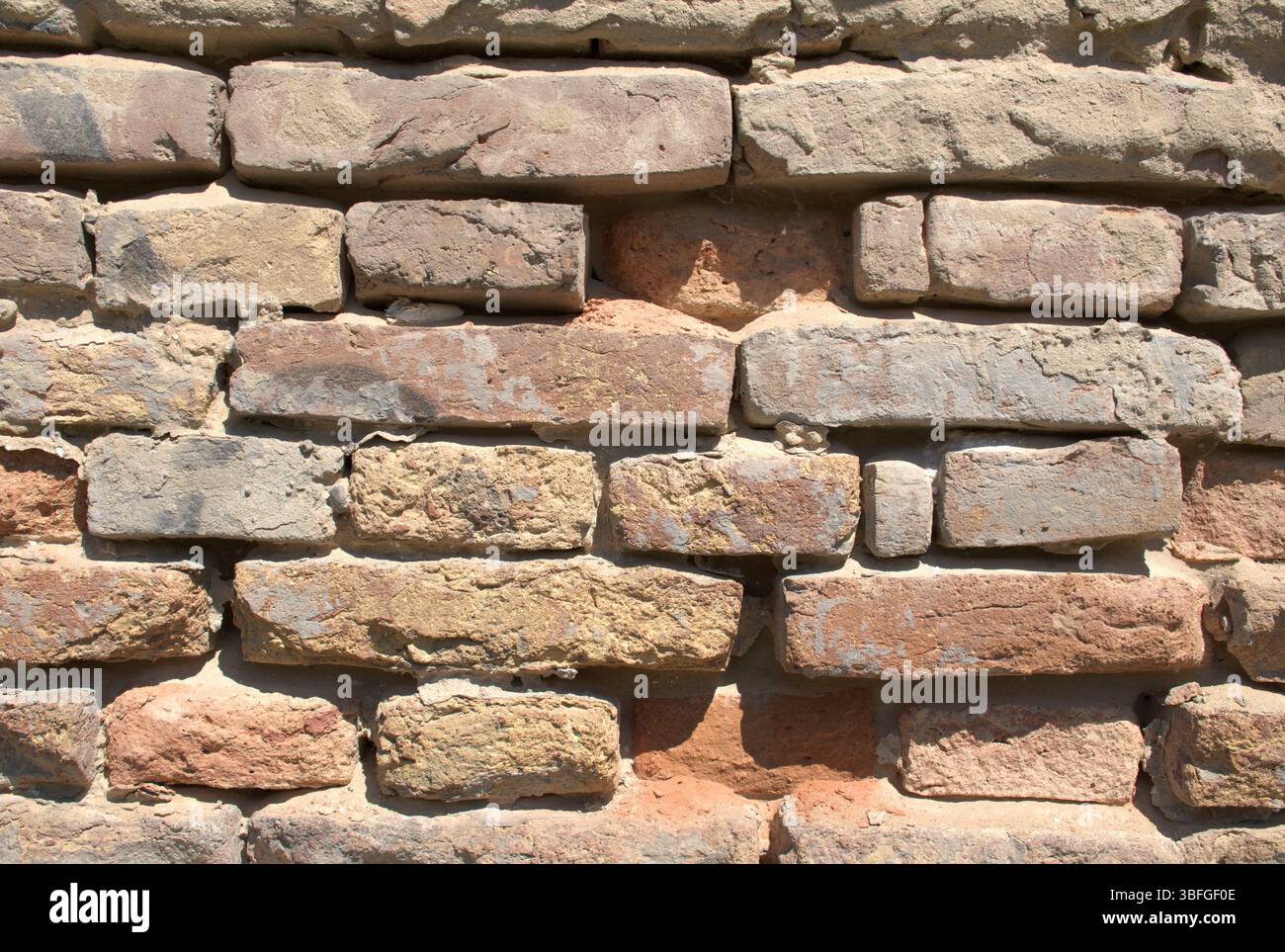 Close-up full-frame old brick wall with weathered, rustic texture and ...